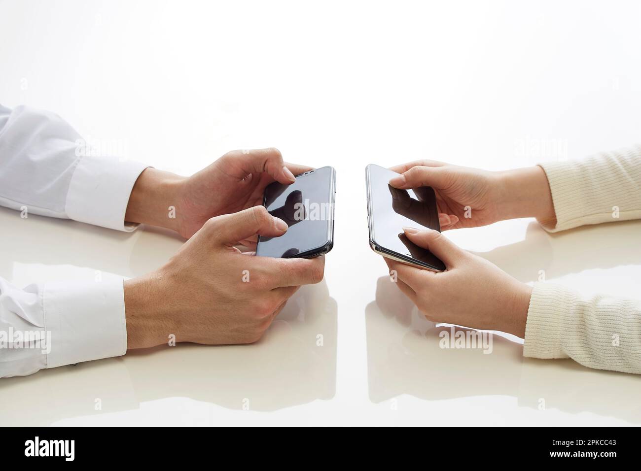 Two hands playing a game with a new smartphone Stock Photo - Alamy