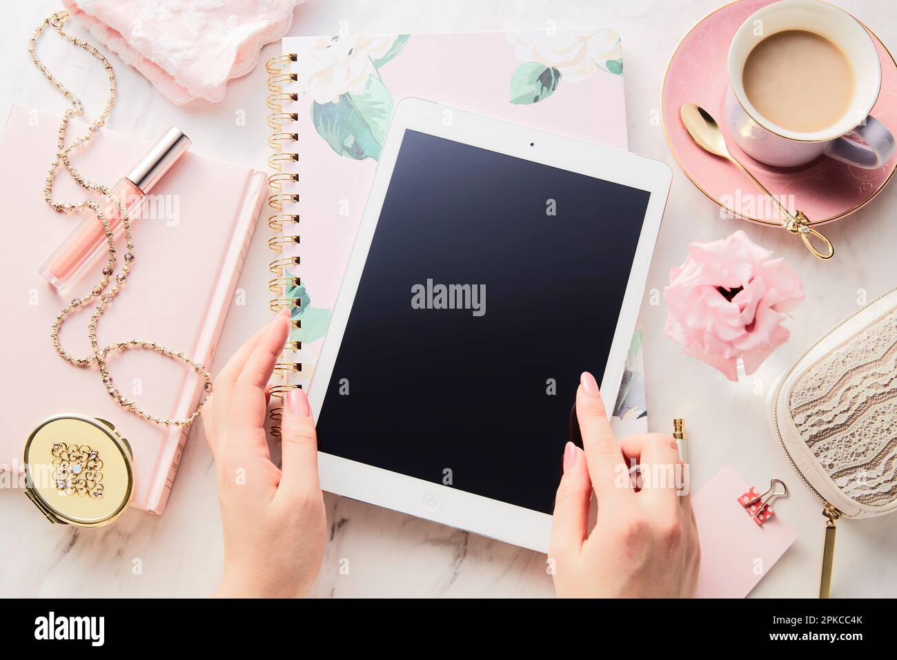 Small items and tablet devices placed on a marble-topped table Stock ...