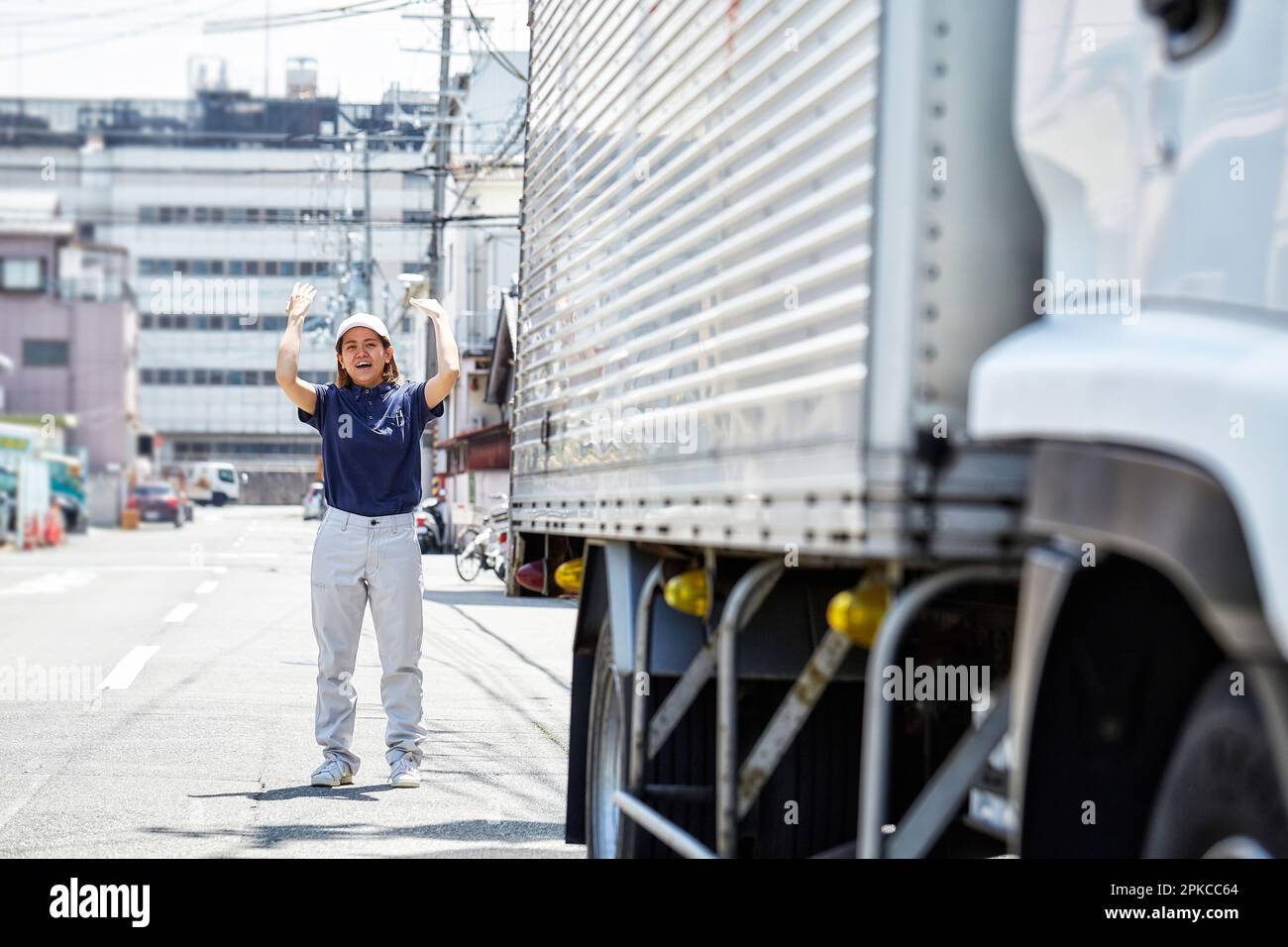 Working woman guiding a big truck Stock Photo - Alamy