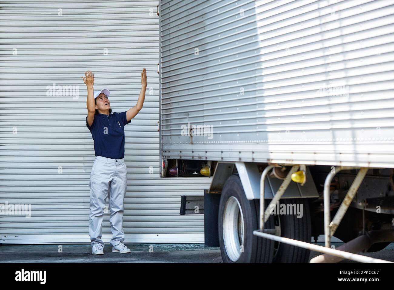 Working woman guiding a big truck Stock Photo - Alamy
