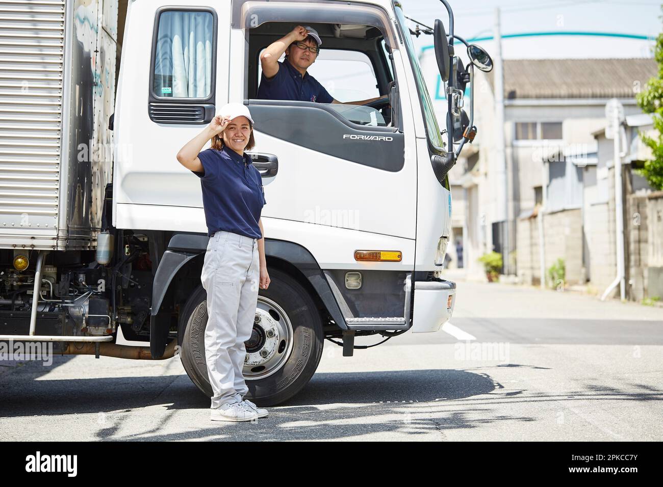 Man riding in truck and woman standing beside him Stock Photo - Alamy