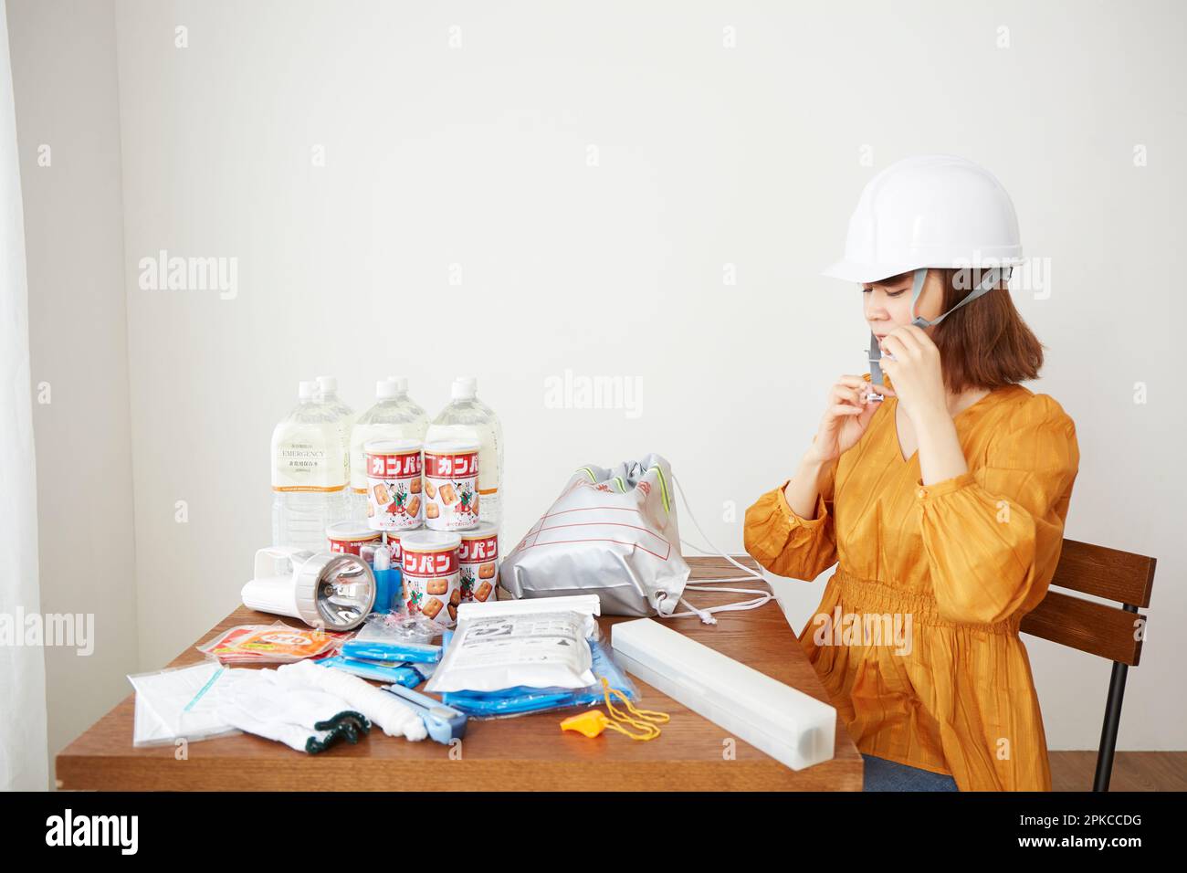 A woman preparing disaster prevention goods Stock Photo - Alamy