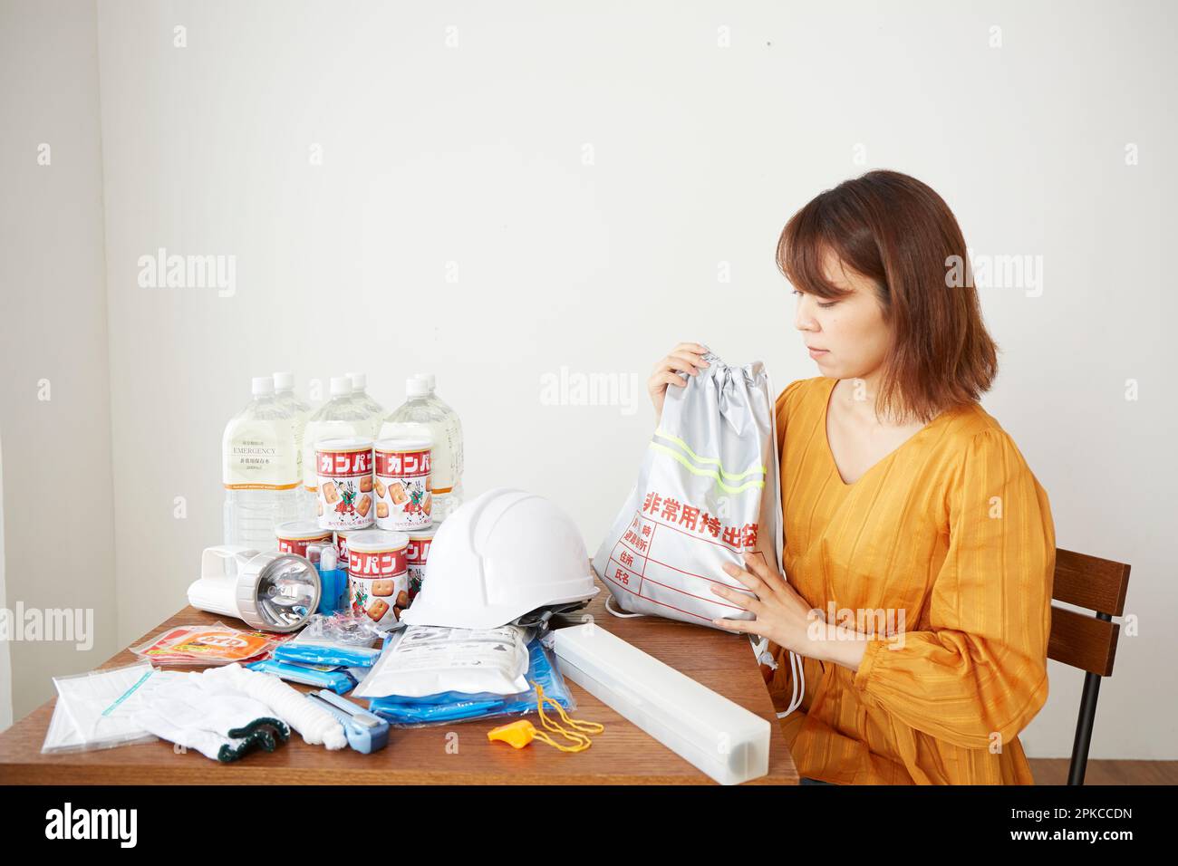 Woman preparing disaster prevention goods Stock Photo - Alamy