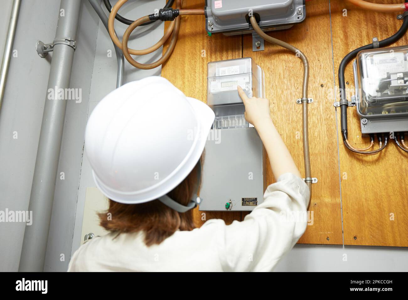 A woman inspects with a helmet Stock Photo - Alamy
