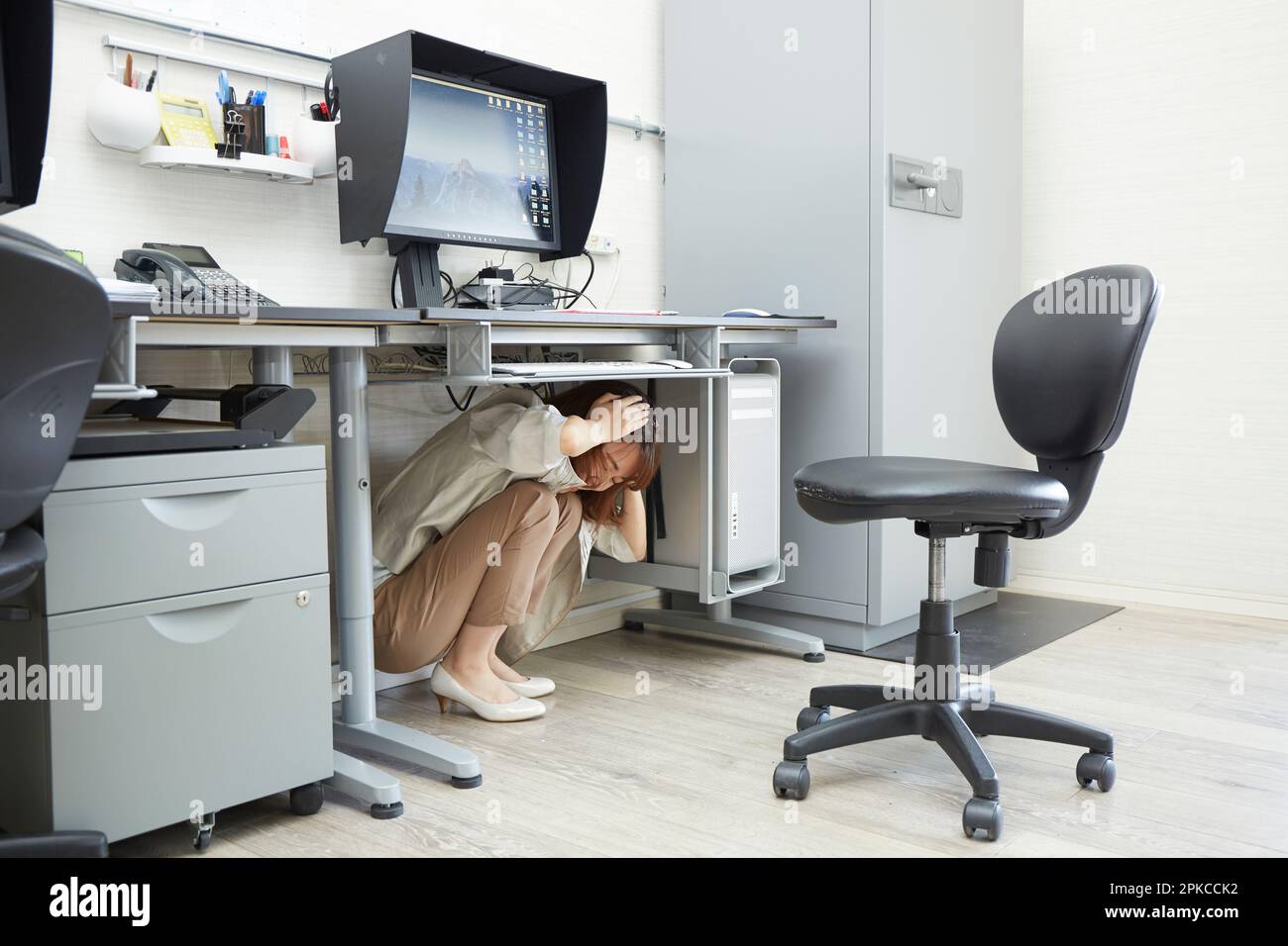 Hiding under desk hi-res stock photography and images - Alamy