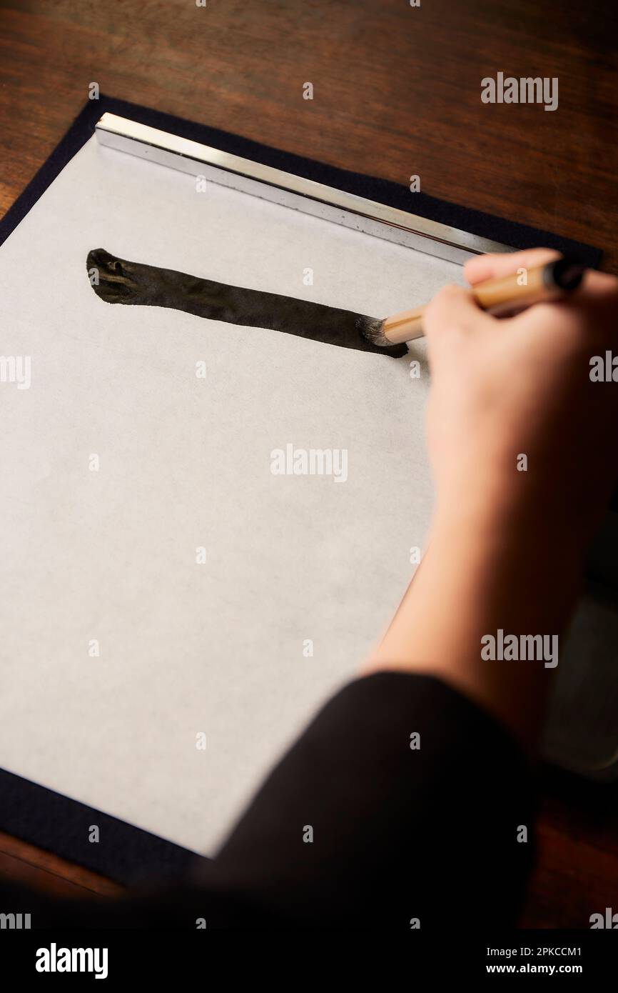 Woman's hands doing calligraphy at a desk Stock Photo - Alamy