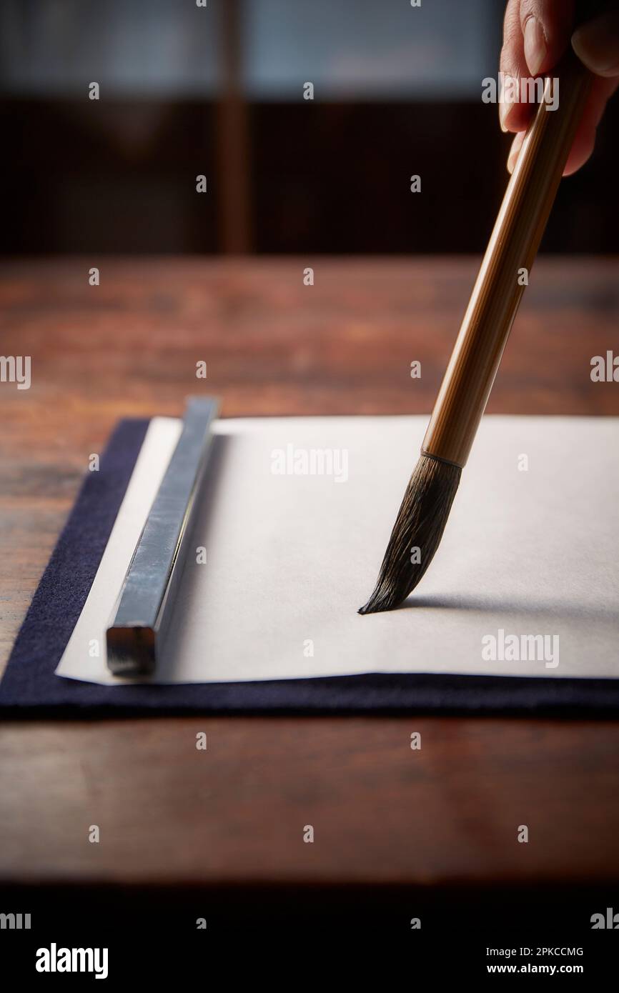 Woman's hand doing calligraphy at a desk Stock Photo - Alamy