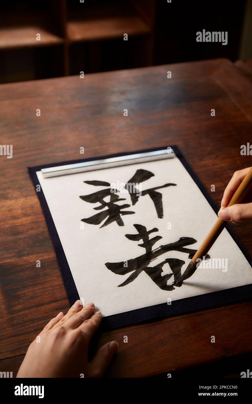 Woman's hand doing calligraphy at a desk Stock Photo - Alamy