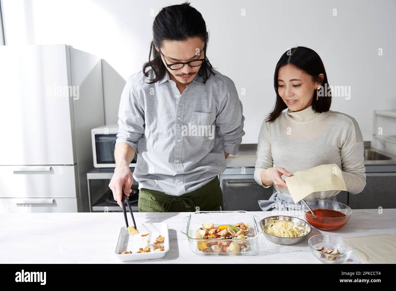 Female cook in process cooking hi-res stock photography and images - Alamy