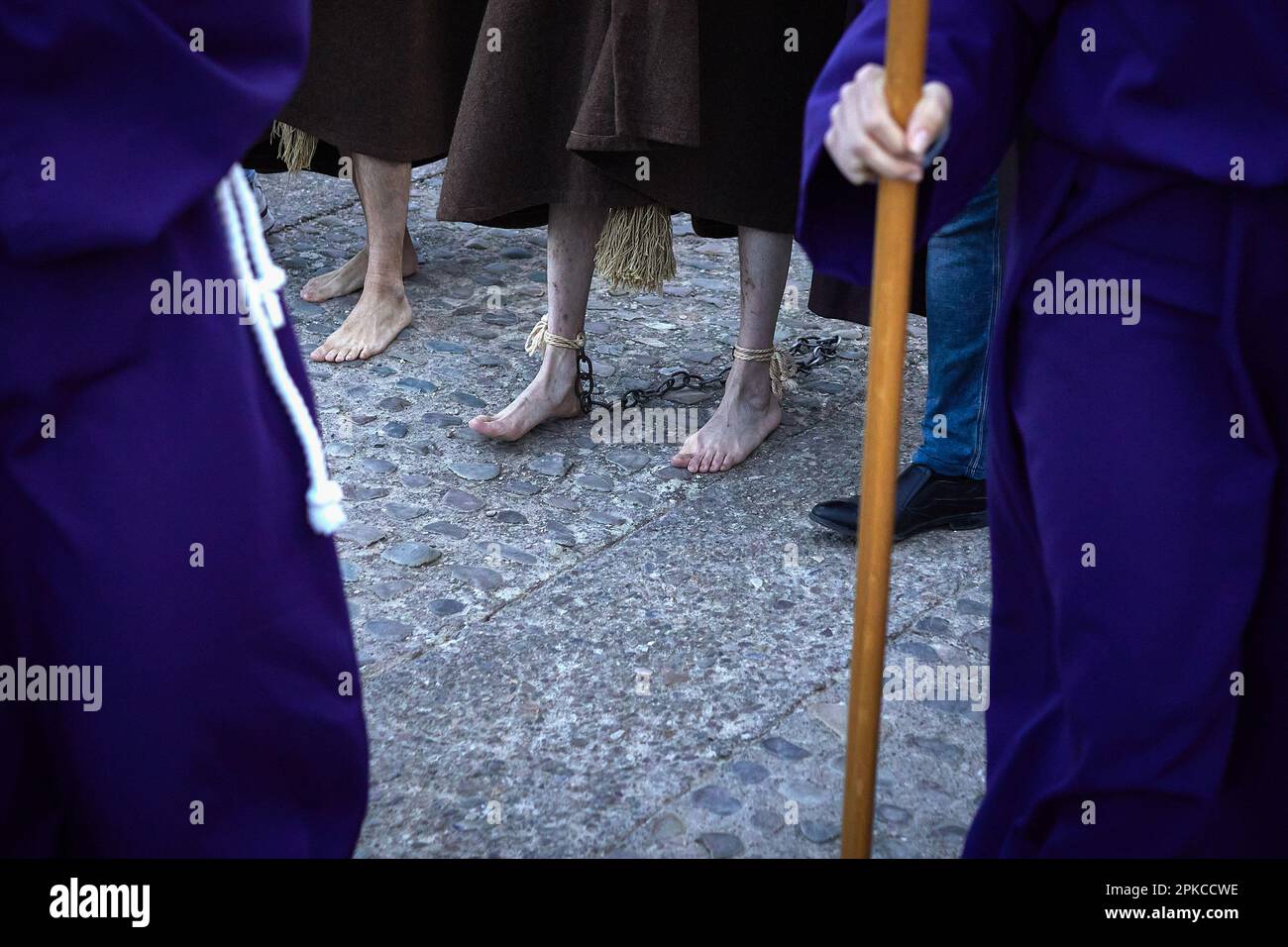 Close-up of the barefoot with chained feet of a disciplinarian. The ...