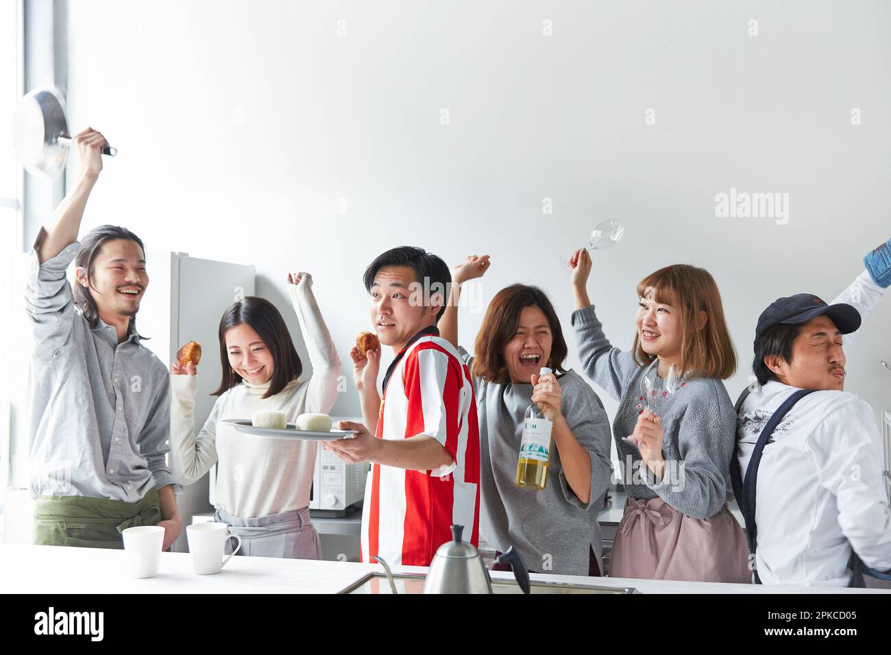 Six men and women dancing in the kitchen Stock Photo - Alamy