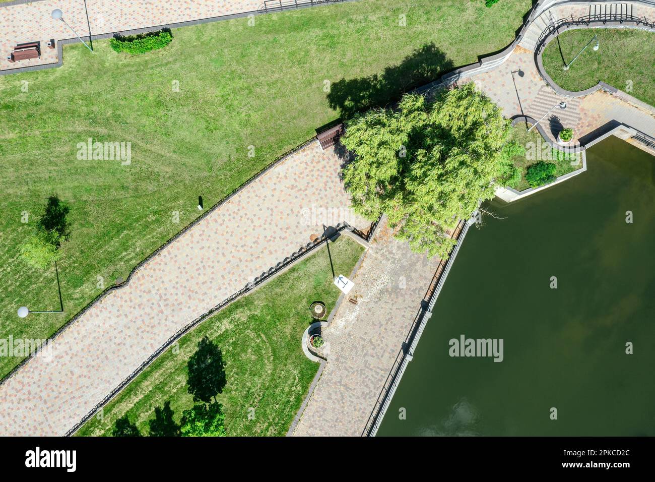 walking paths on riverbank in summer city park. bright sunny day ...