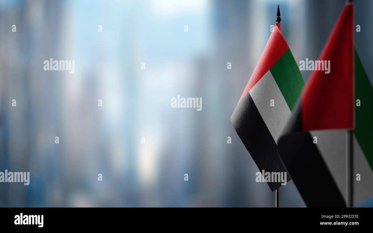 Small flags of the Arab Emirates on an abstract blurry background Stock ...