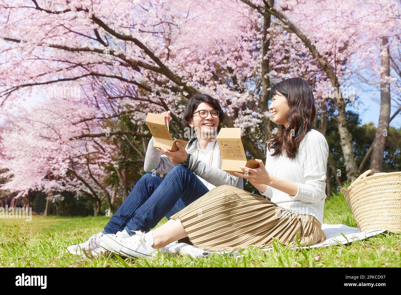 Couple eating lunch under a cherry tree Stock Photo - Alamy