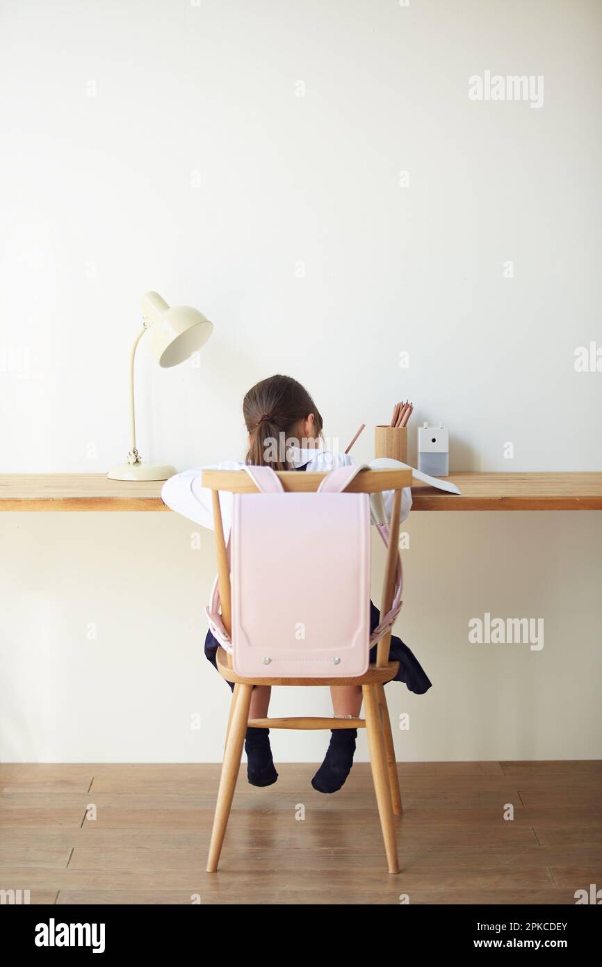 Elementary school girl studying at her desk Stock Photo - Alamy