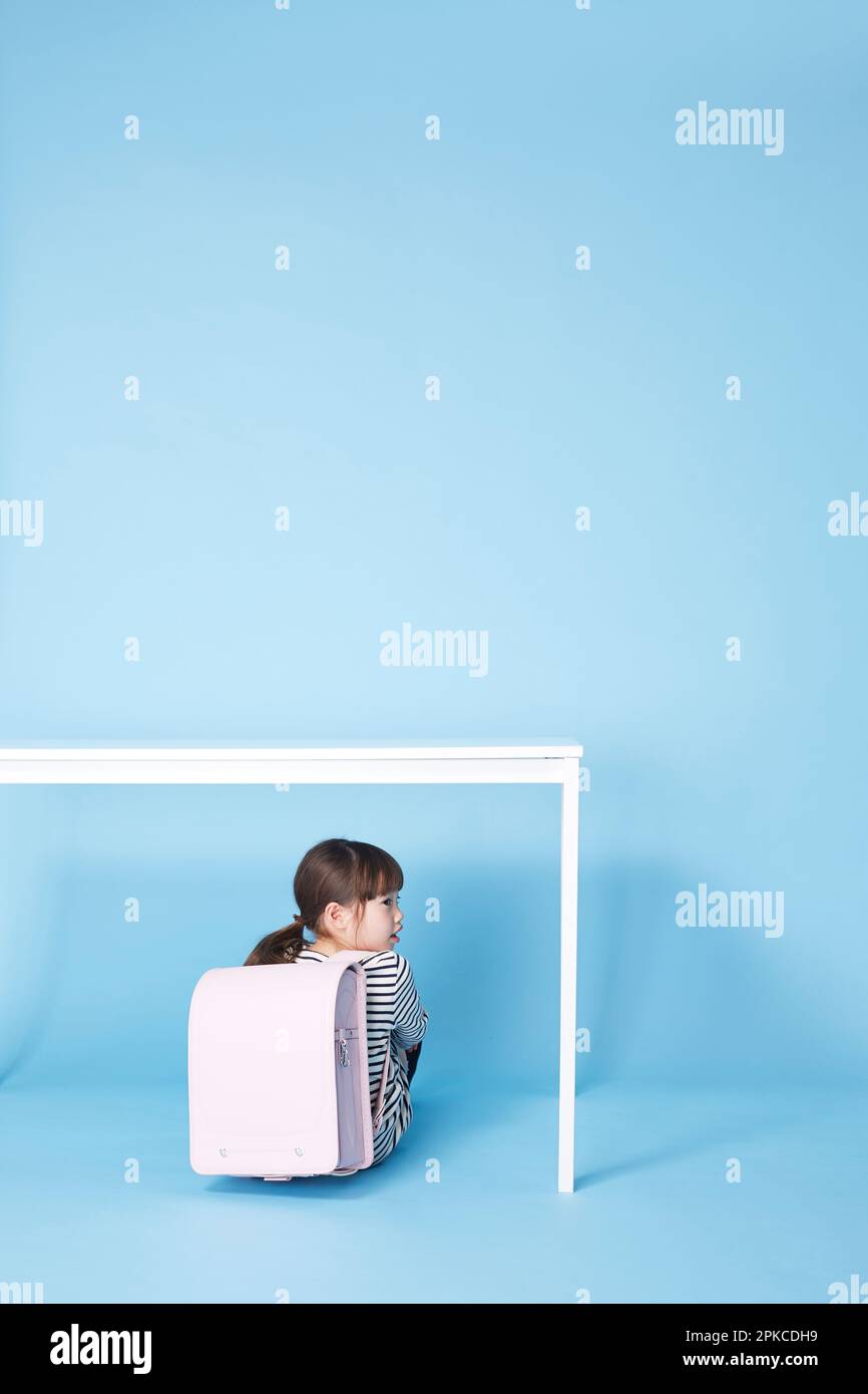 Girl hiding under table hi-res stock photography and images - Alamy