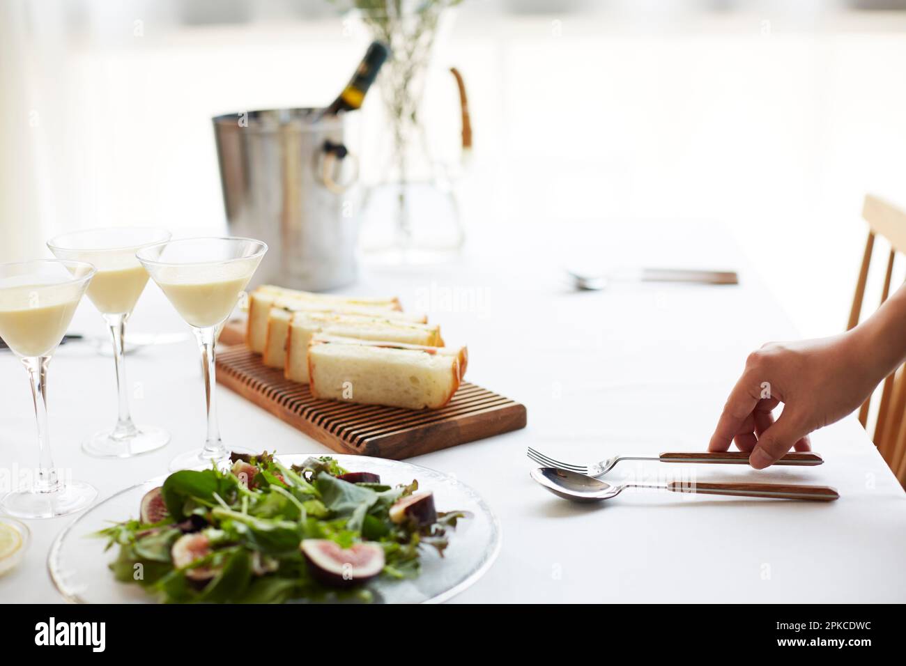 Woman setting the table for a home party Stock Photo - Alamy