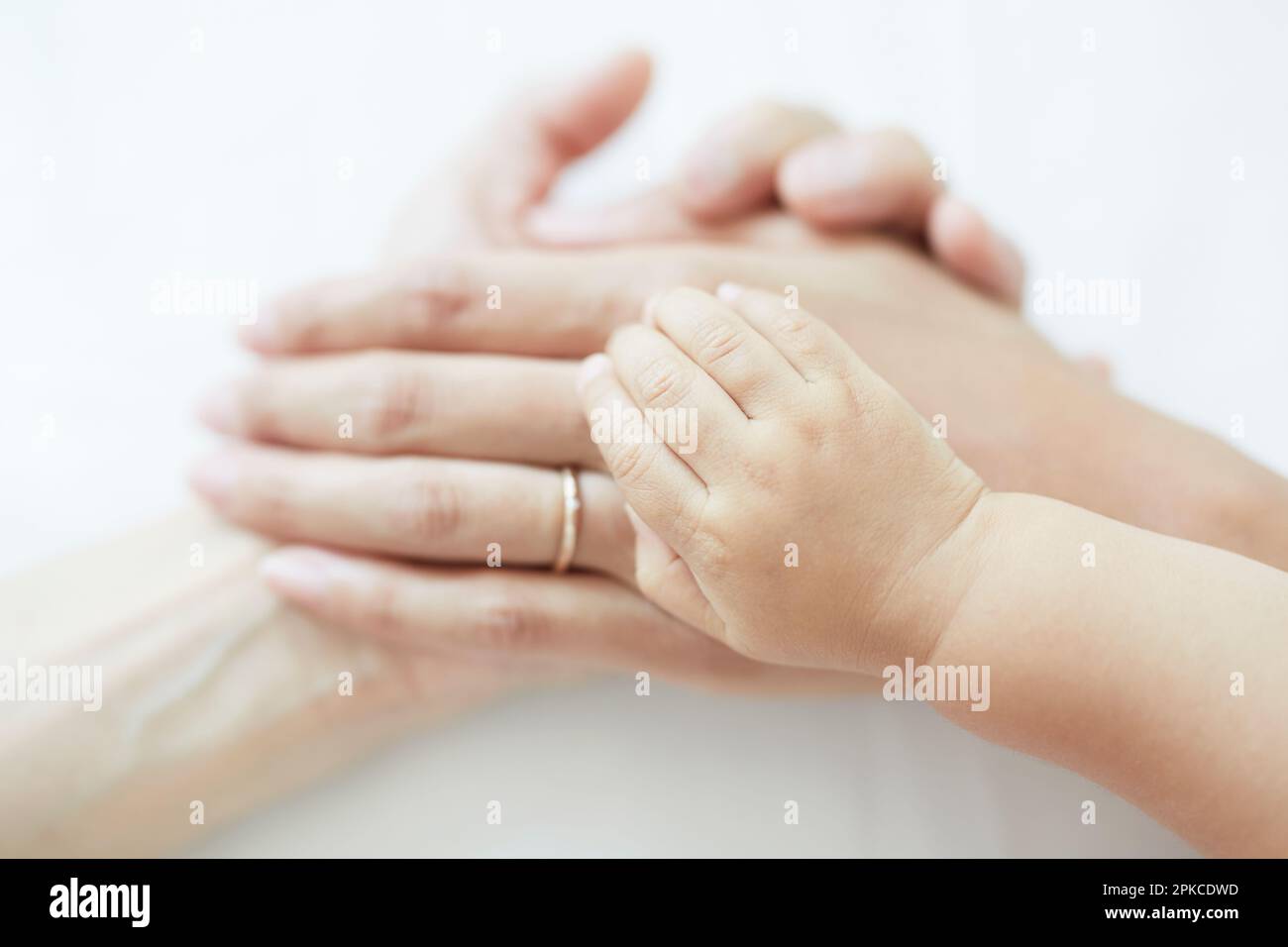 Overlapping hands of father, mother and daughter Stock Photo - Alamy