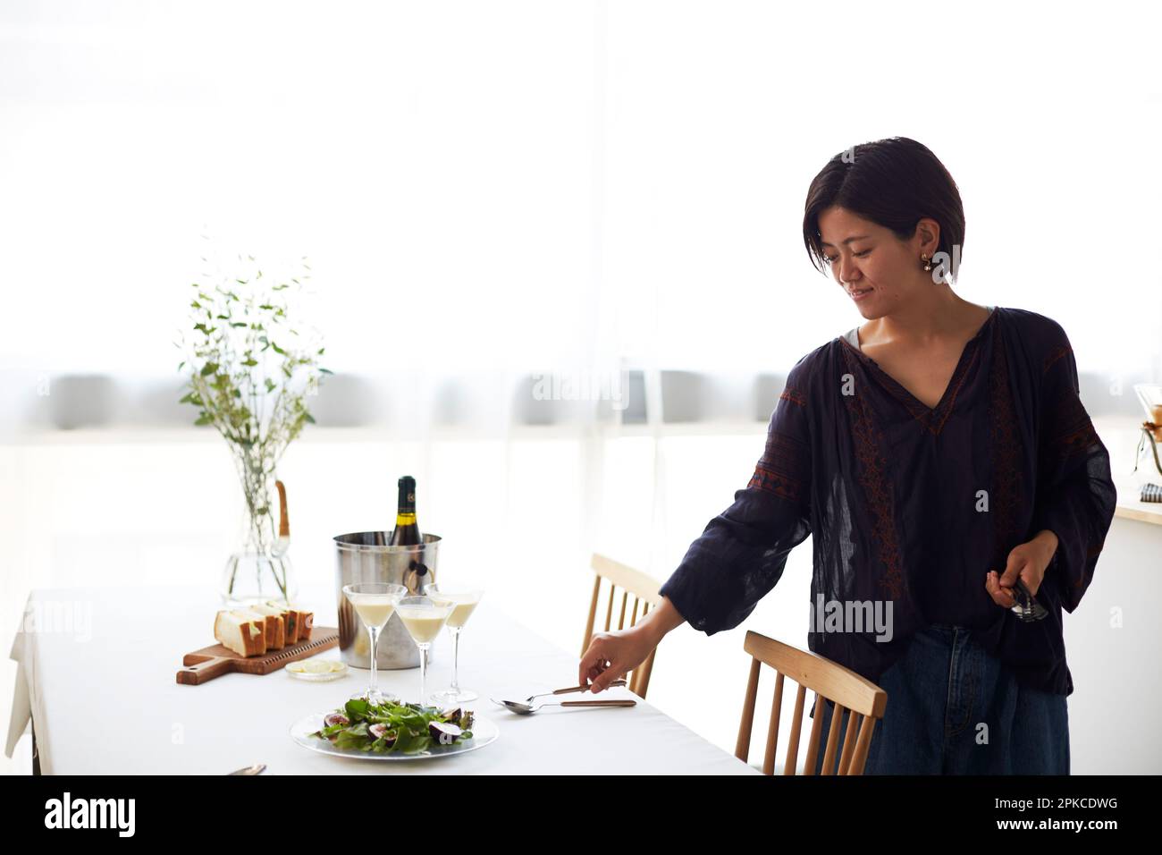 Woman Setting Table for Home Party Stock Photo - Alamy