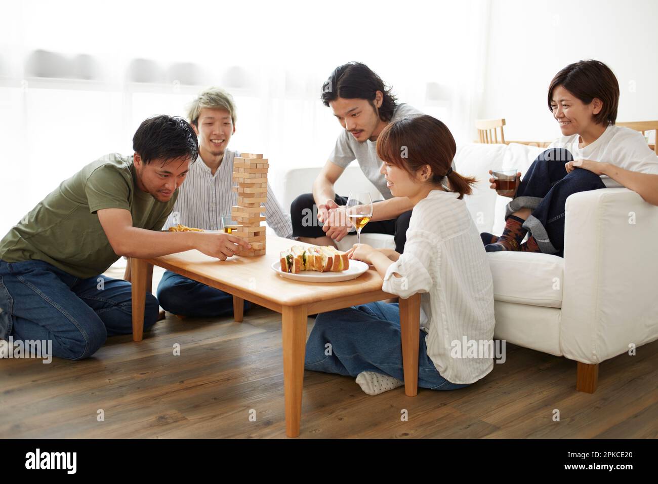 Men and women playing a balancing game Stock Photo - Alamy
