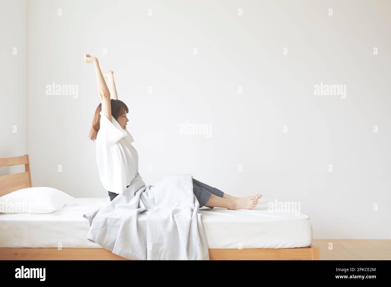 Woman stretching on bed soft hi-res stock photography and images - Alamy