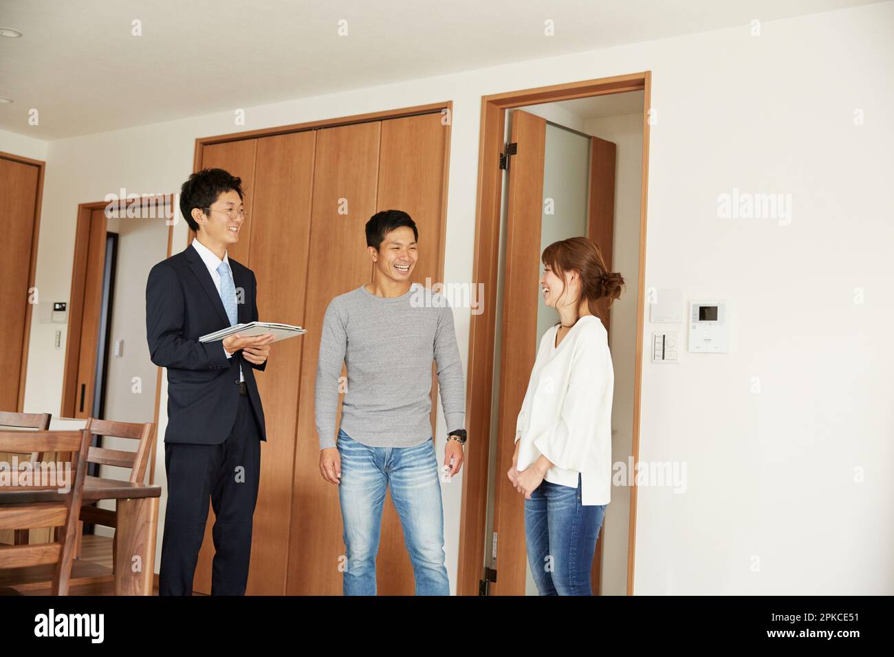 A couple receiving an explanation of the handover of their new house ...