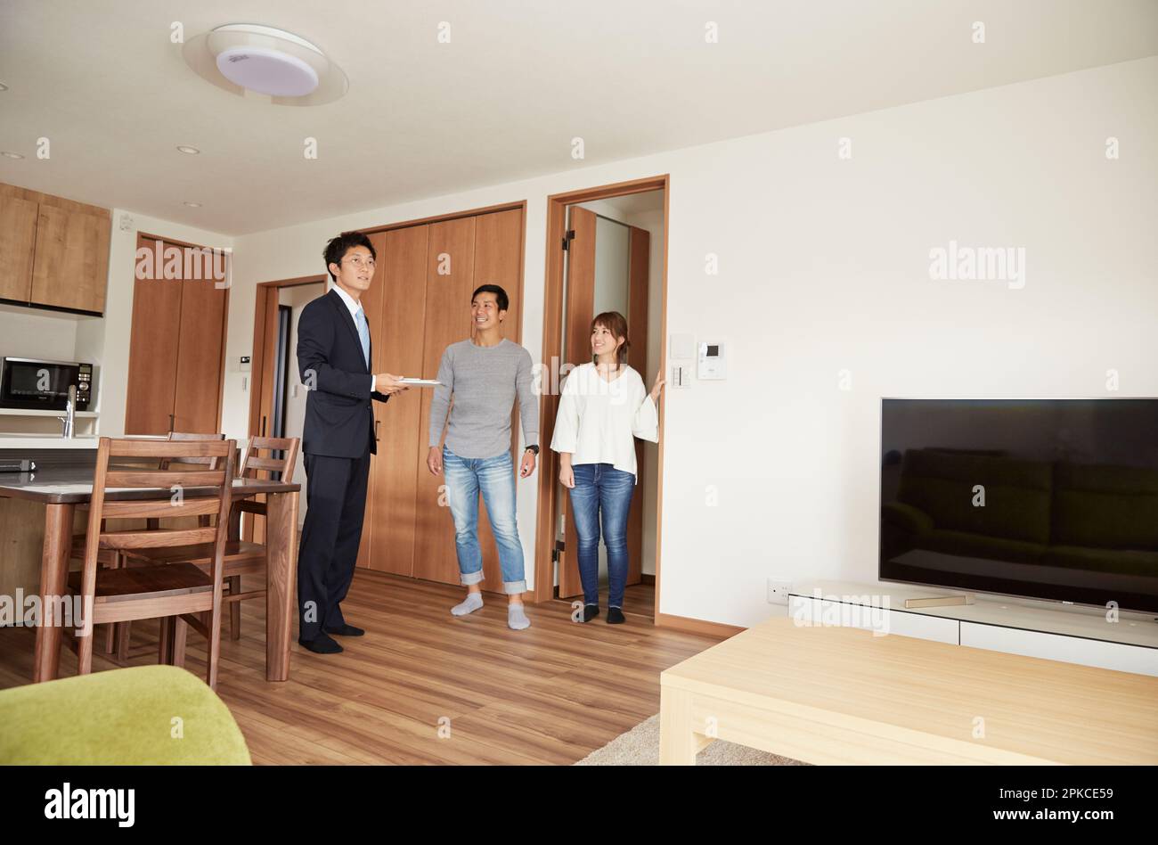 A couple receiving an explanation of the handover of their new house ...