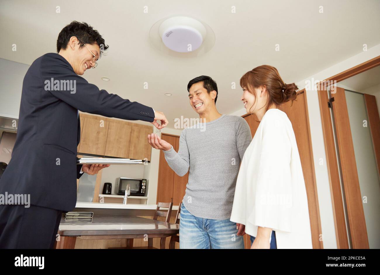 A couple receiving an explanation of the handover of their new house ...