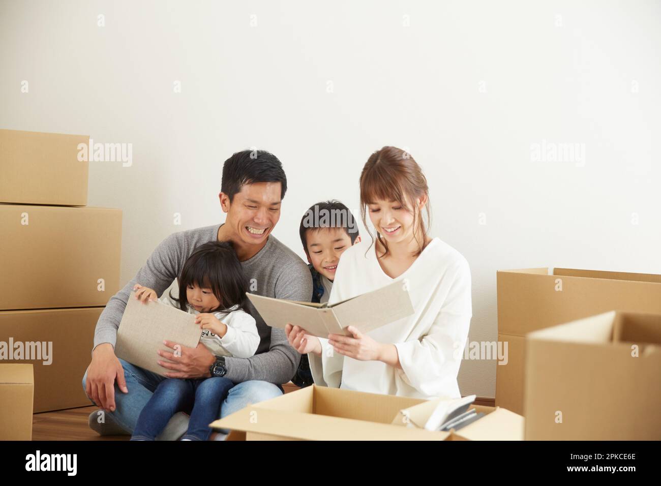 Asian family unpacking cardboard hi-res stock photography and images ...