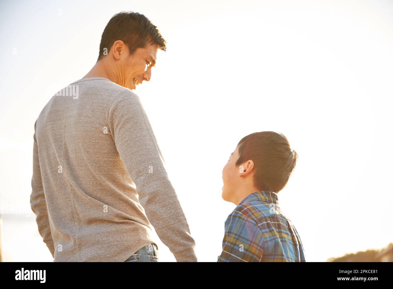 Parents and children going outside to play together Stock Photo - Alamy