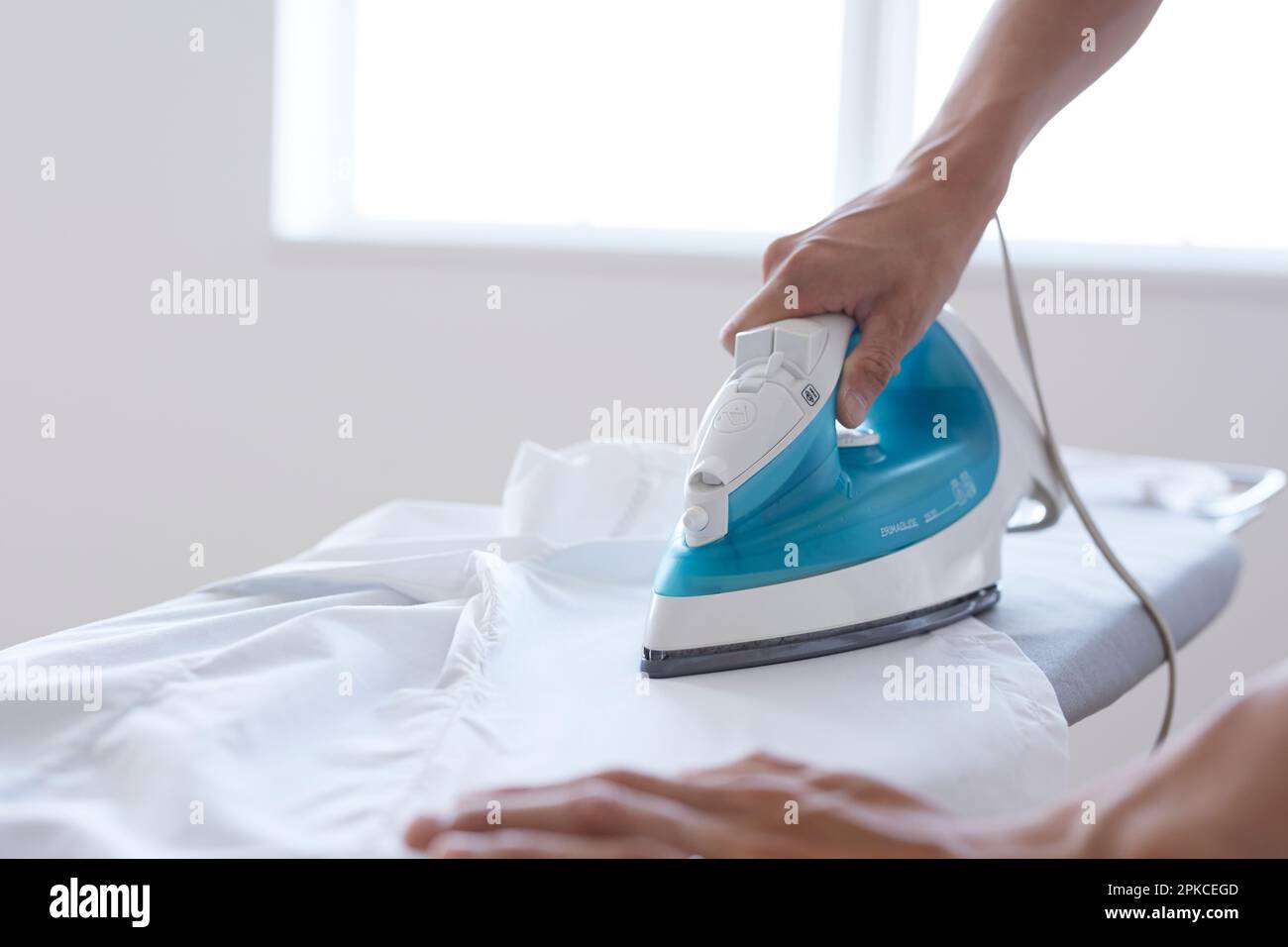 Male hand ironing white hi-res stock photography and images - Alamy