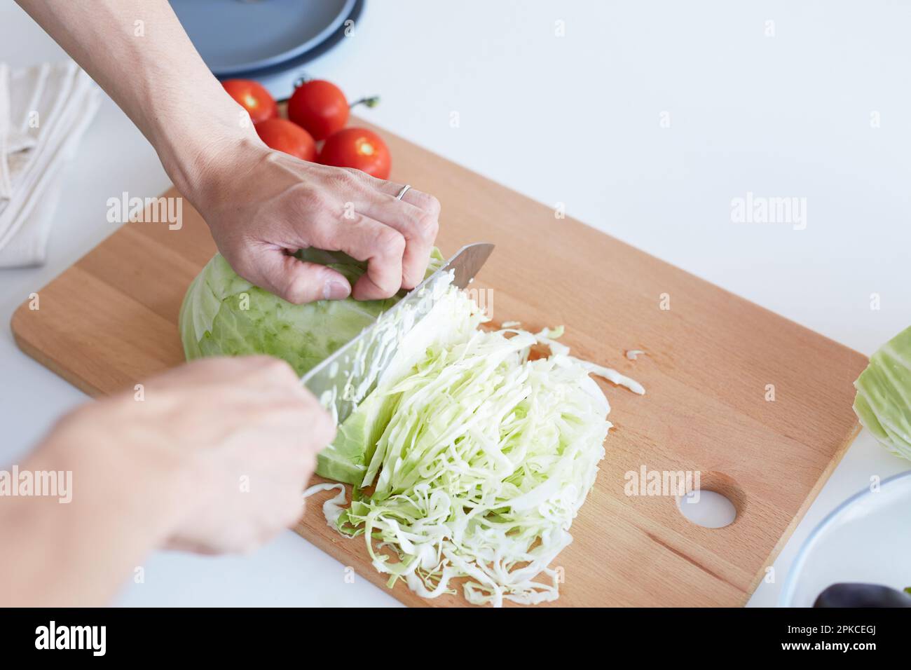 Man cutting cabbage into strips Stock Photo - Alamy