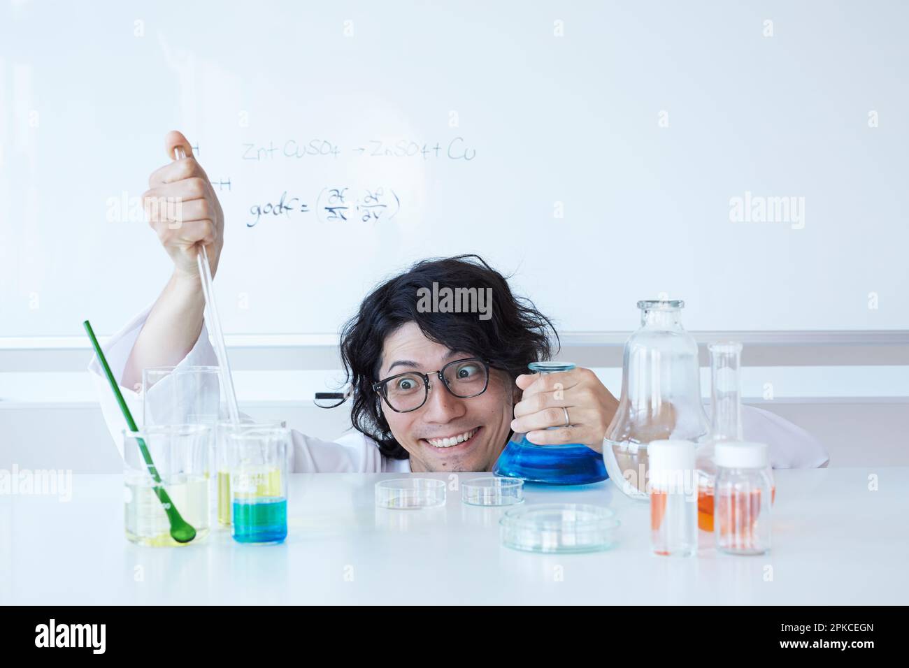 Man happily experimenting with mixing liquids Stock Photo - Alamy