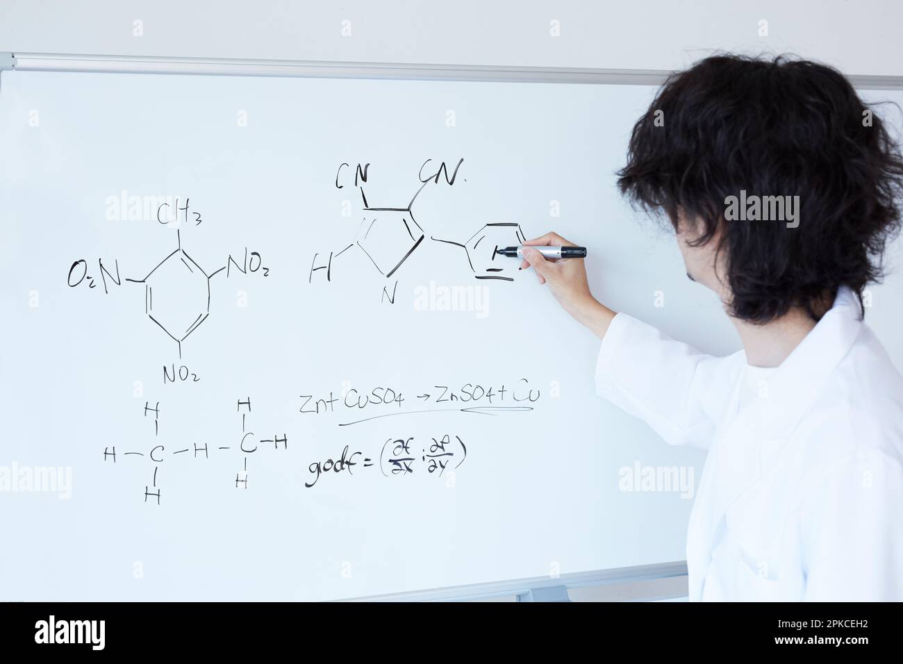 Chemist making notes on whiteboard Stock Photo - Alamy