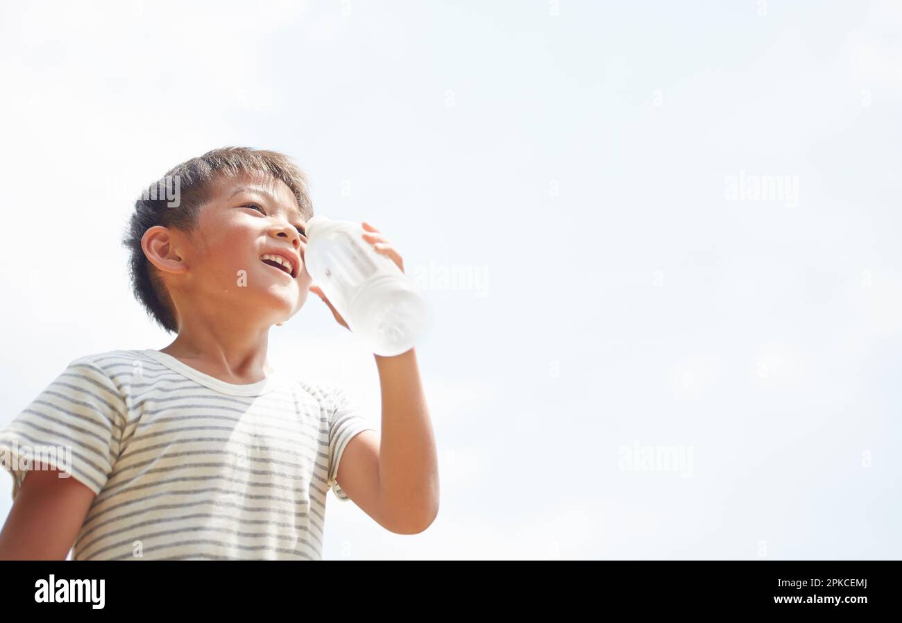 Sweaty boy drinking water Stock Photo - Alamy