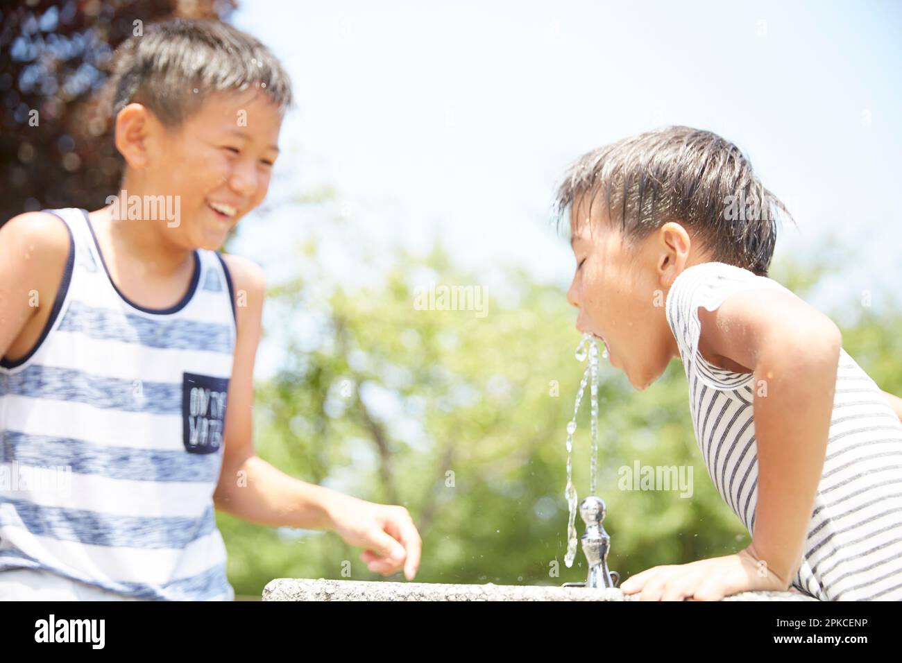 Boy drinking water at water fountain Stock Photo - Alamy