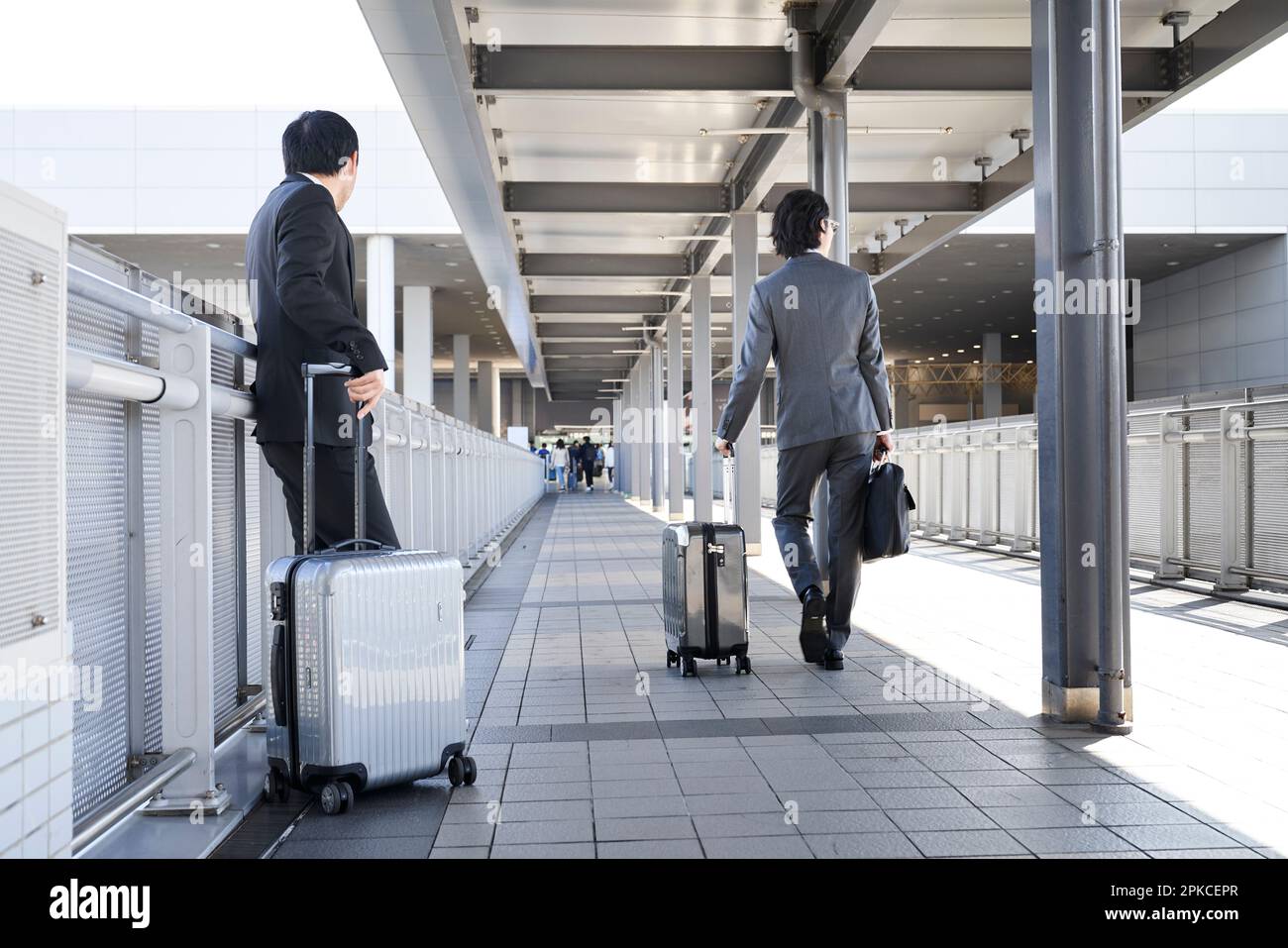 office worker pulling a carrying case Stock Photo - Alamy