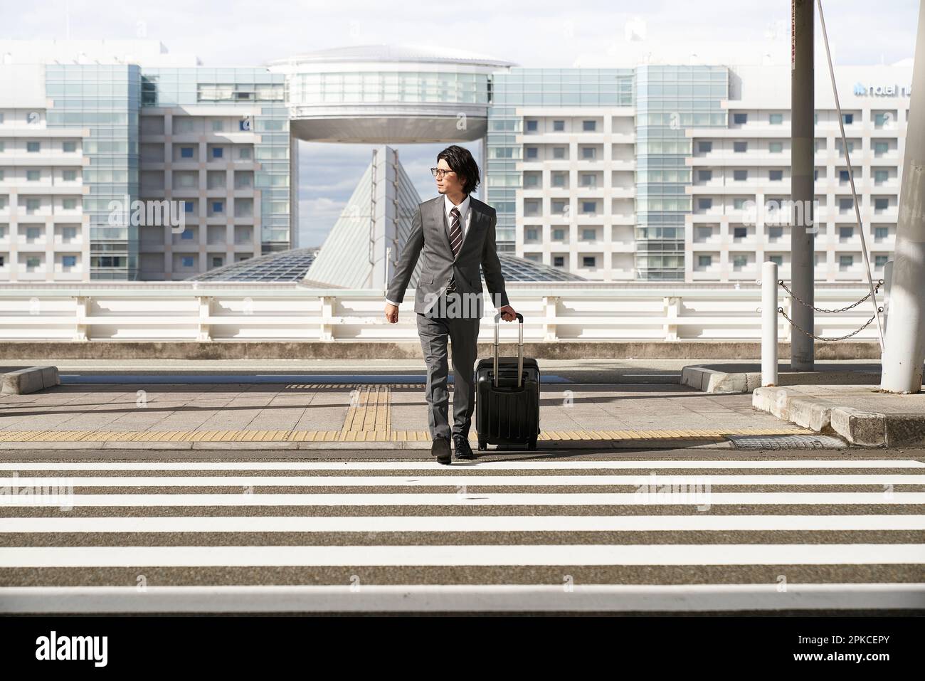 office worker pulling a carrying case Stock Photo - Alamy