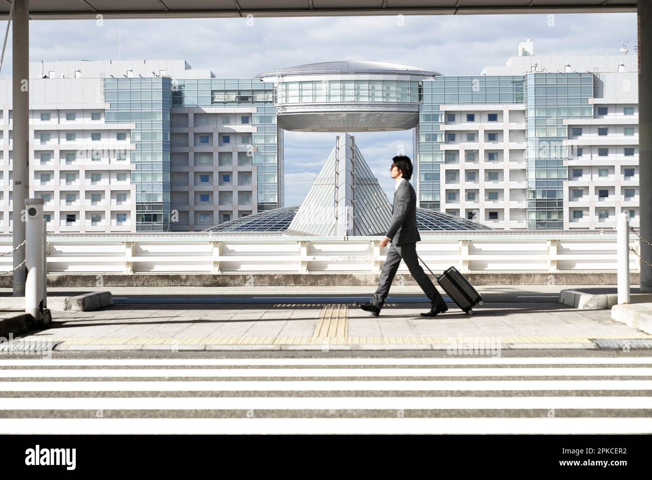 office worker pulling a carrying case Stock Photo - Alamy