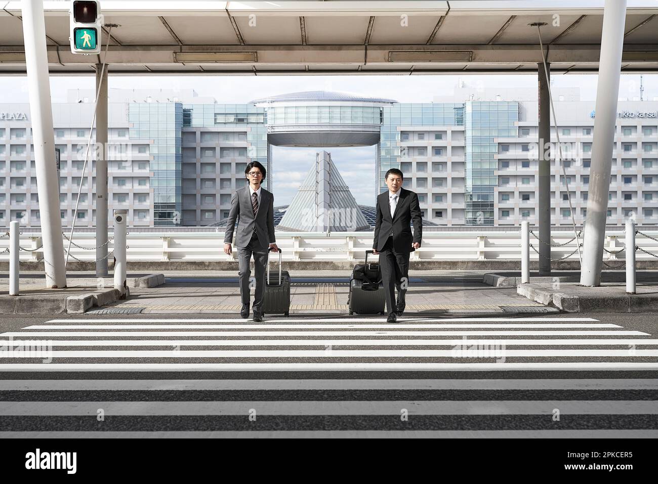 office worker pulling a carrying case Stock Photo - Alamy