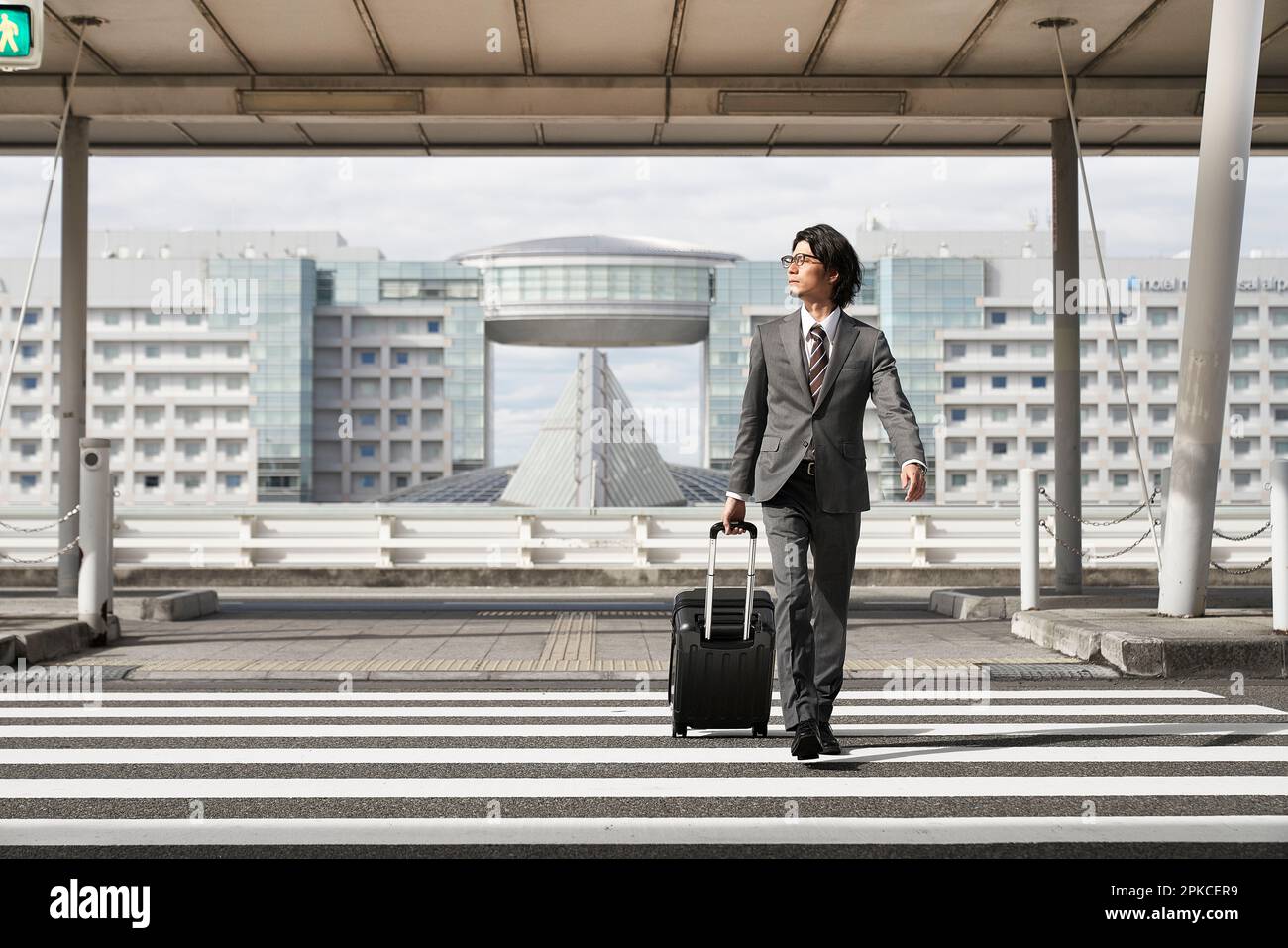 office worker pulling a carrying case Stock Photo - Alamy