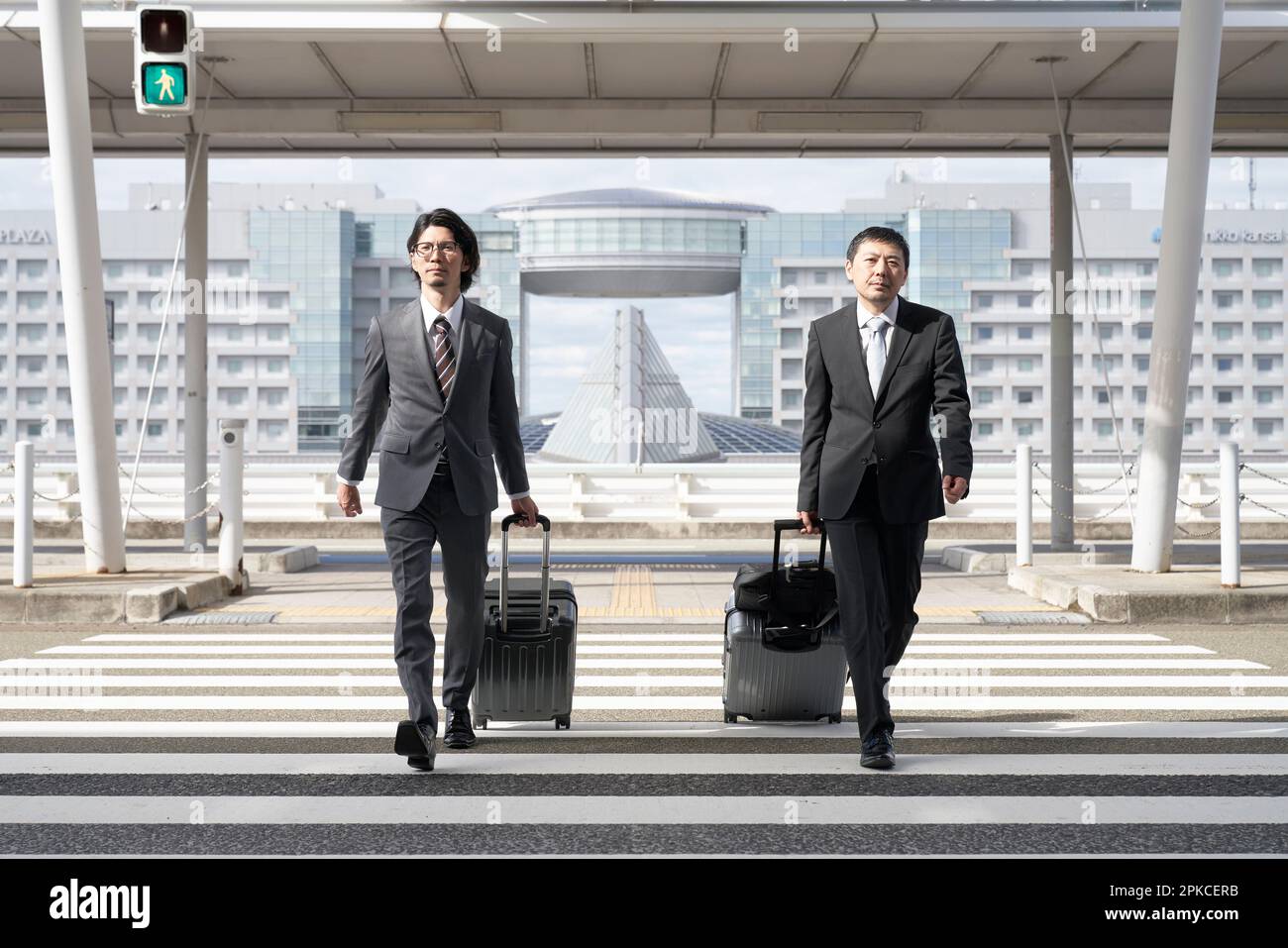 office worker pulling a carrying case Stock Photo - Alamy