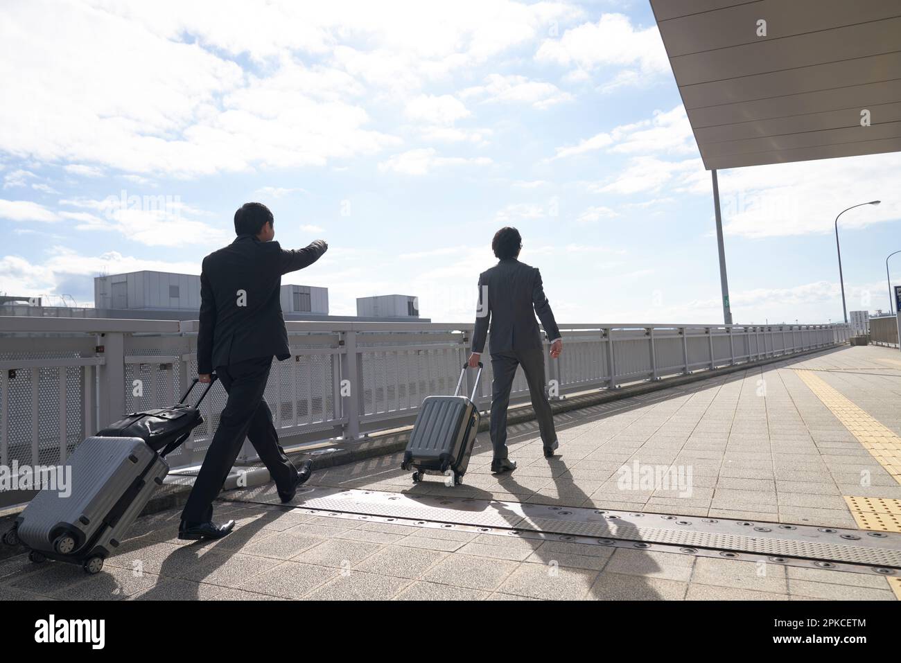 office worker pulling a carrying case Stock Photo - Alamy