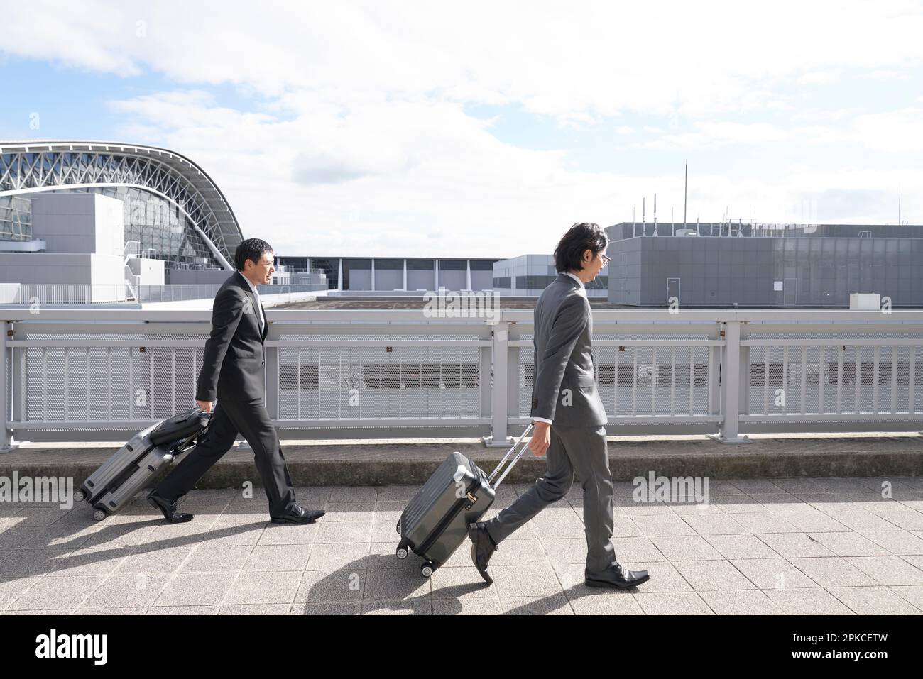 office worker pulling a carrying case Stock Photo - Alamy