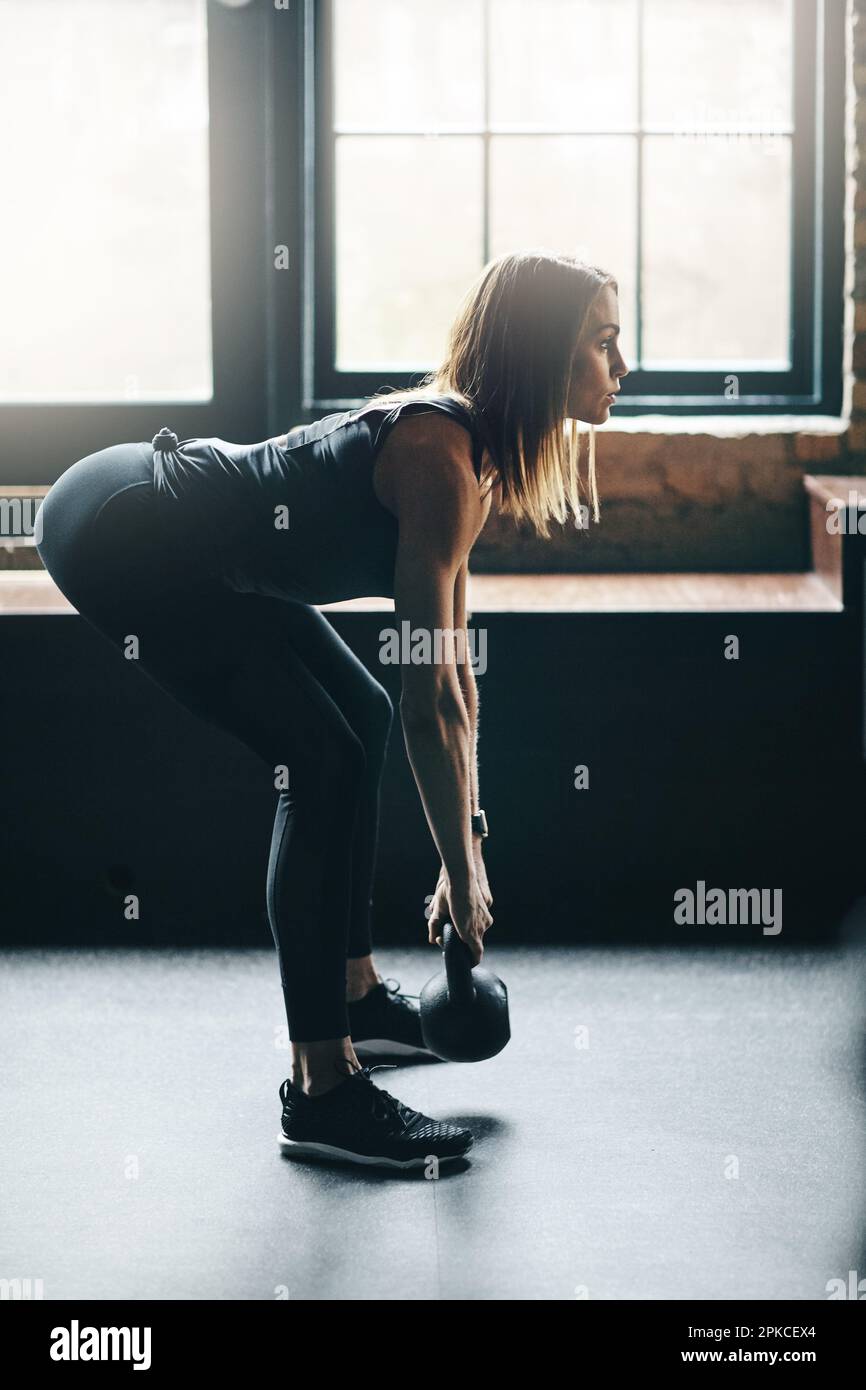 No wishing, just pure hard work. a young woman working out with a ...