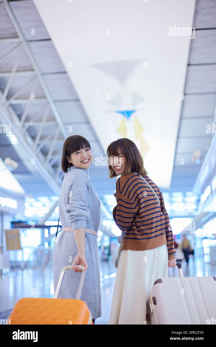 Two women looking back at each other Stock Photo - Alamy