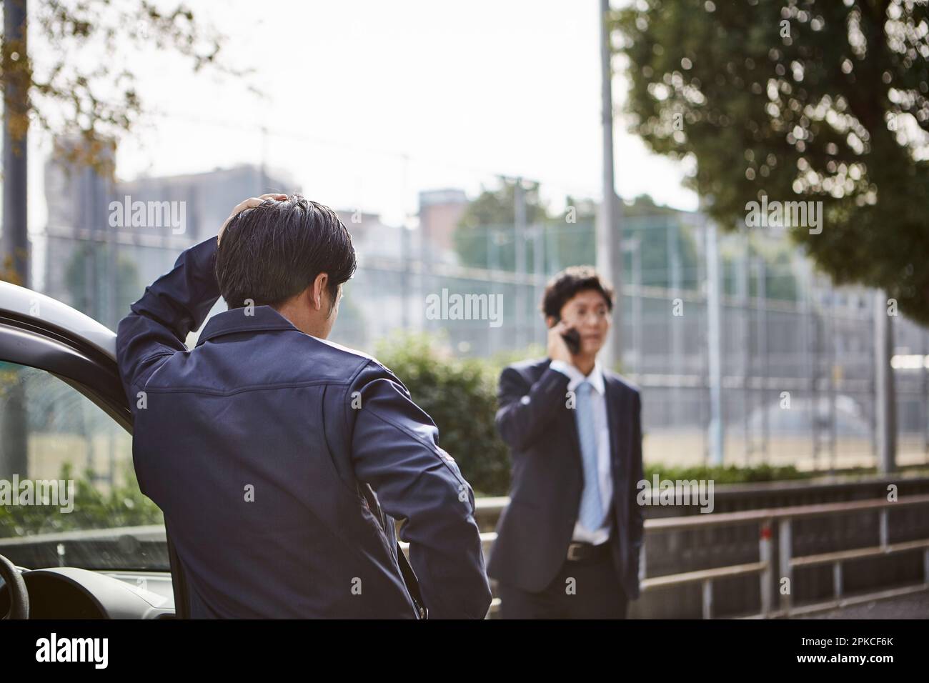 Asian male standing next hi-res stock photography and images - Alamy