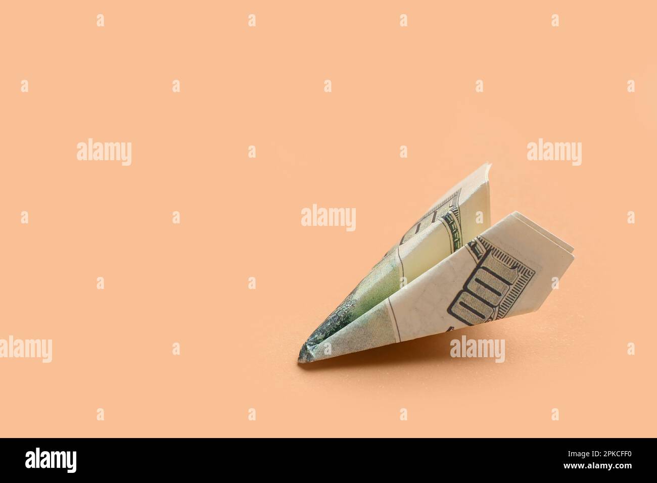 Origami plane made of dollar banknote on beige background Stock Photo ...