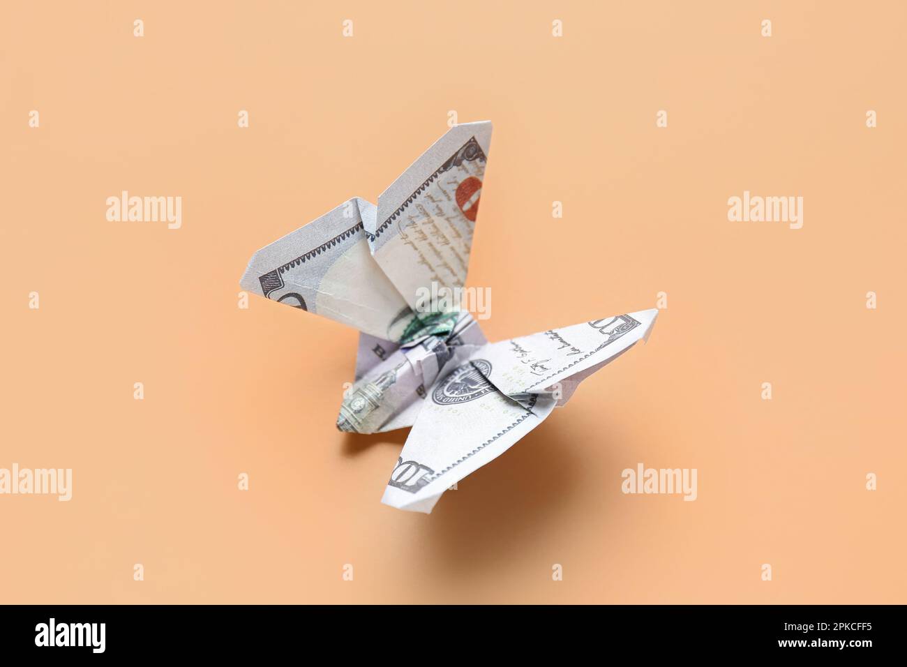Origami butterfly made of dollar banknotes on beige background Stock ...