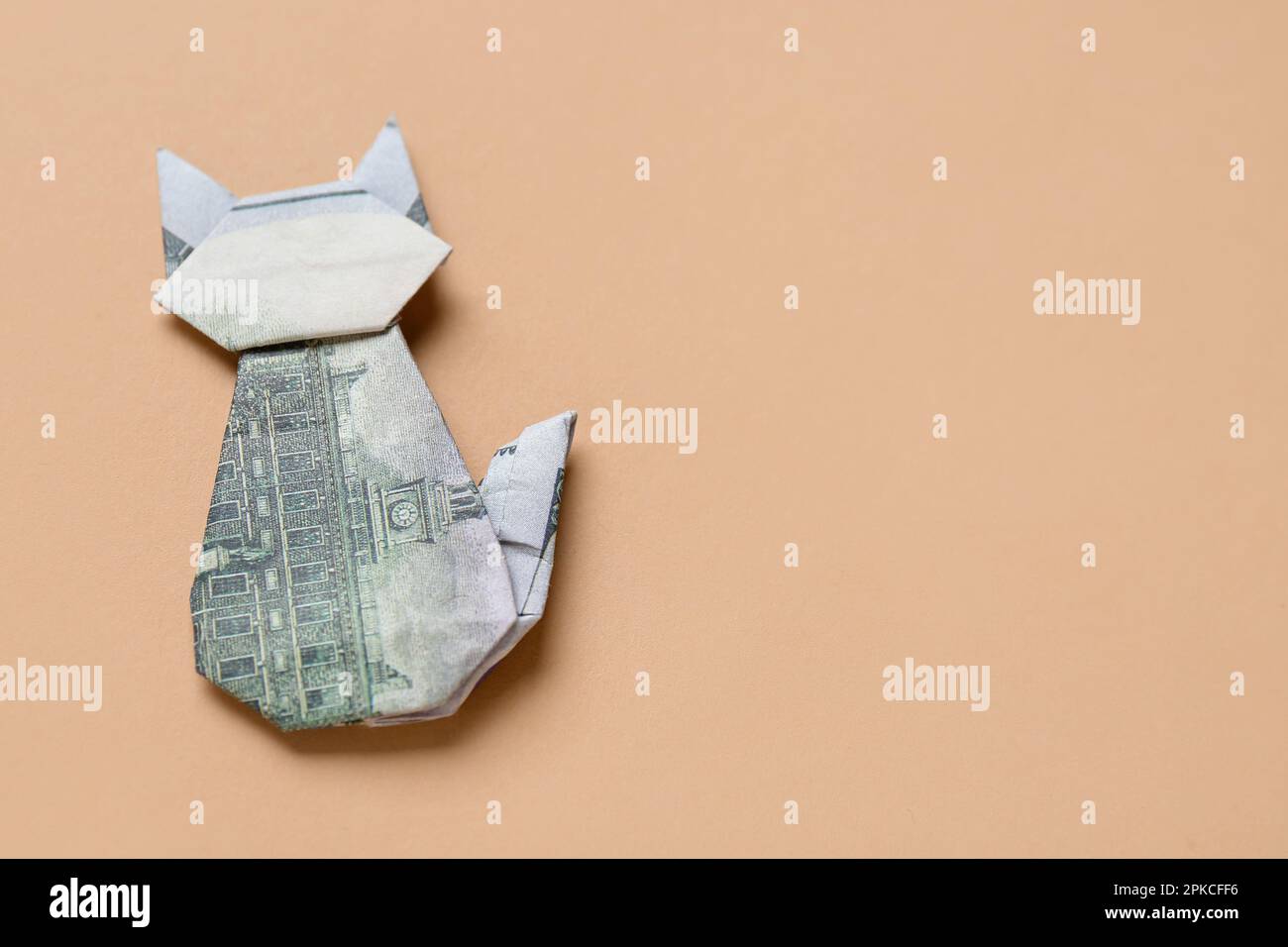 Origami cat made of dollar banknotes on beige background Stock Photo ...